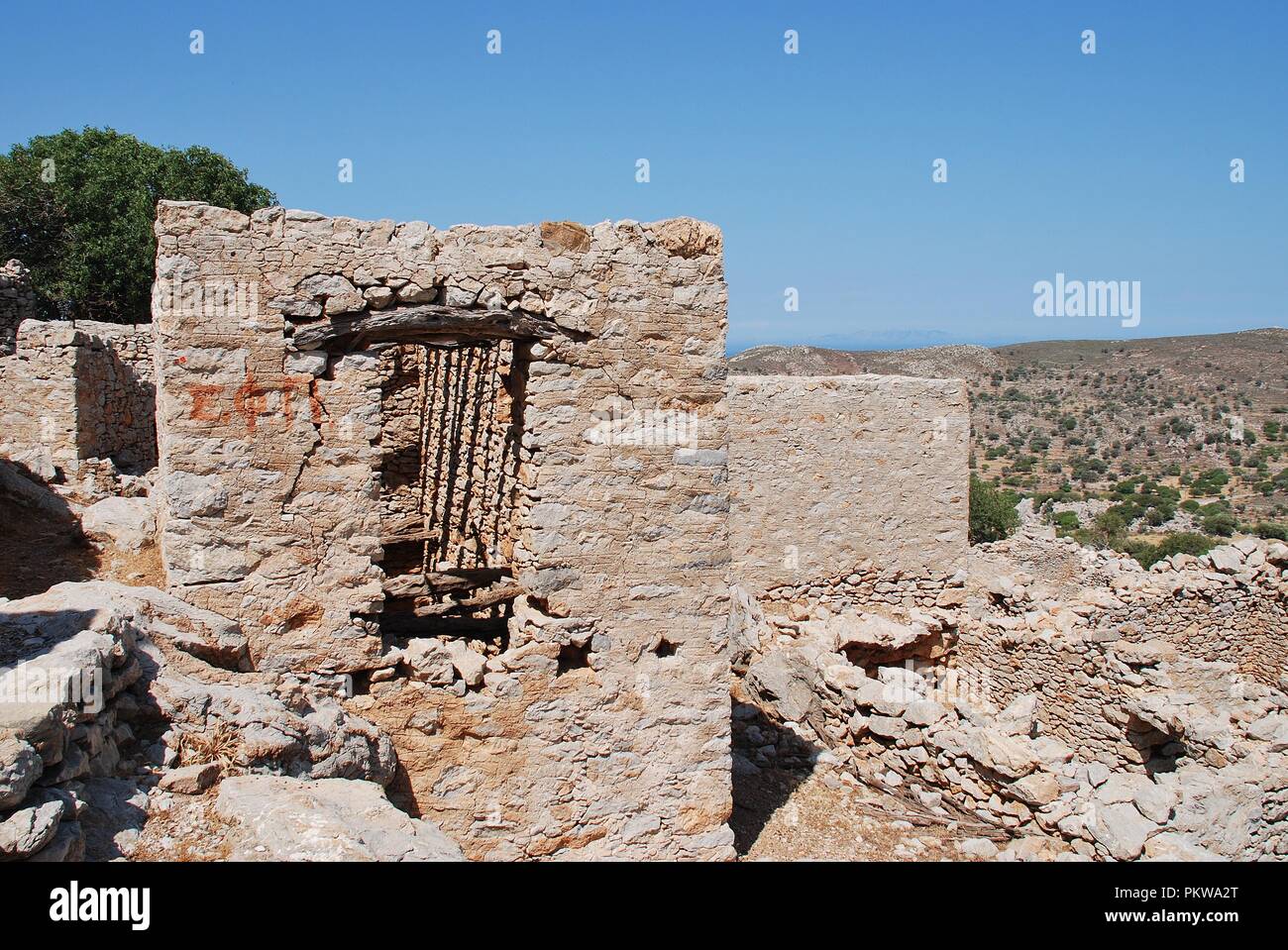The ruins of the abandoned village of Mikro Chorio on the Greek island ...