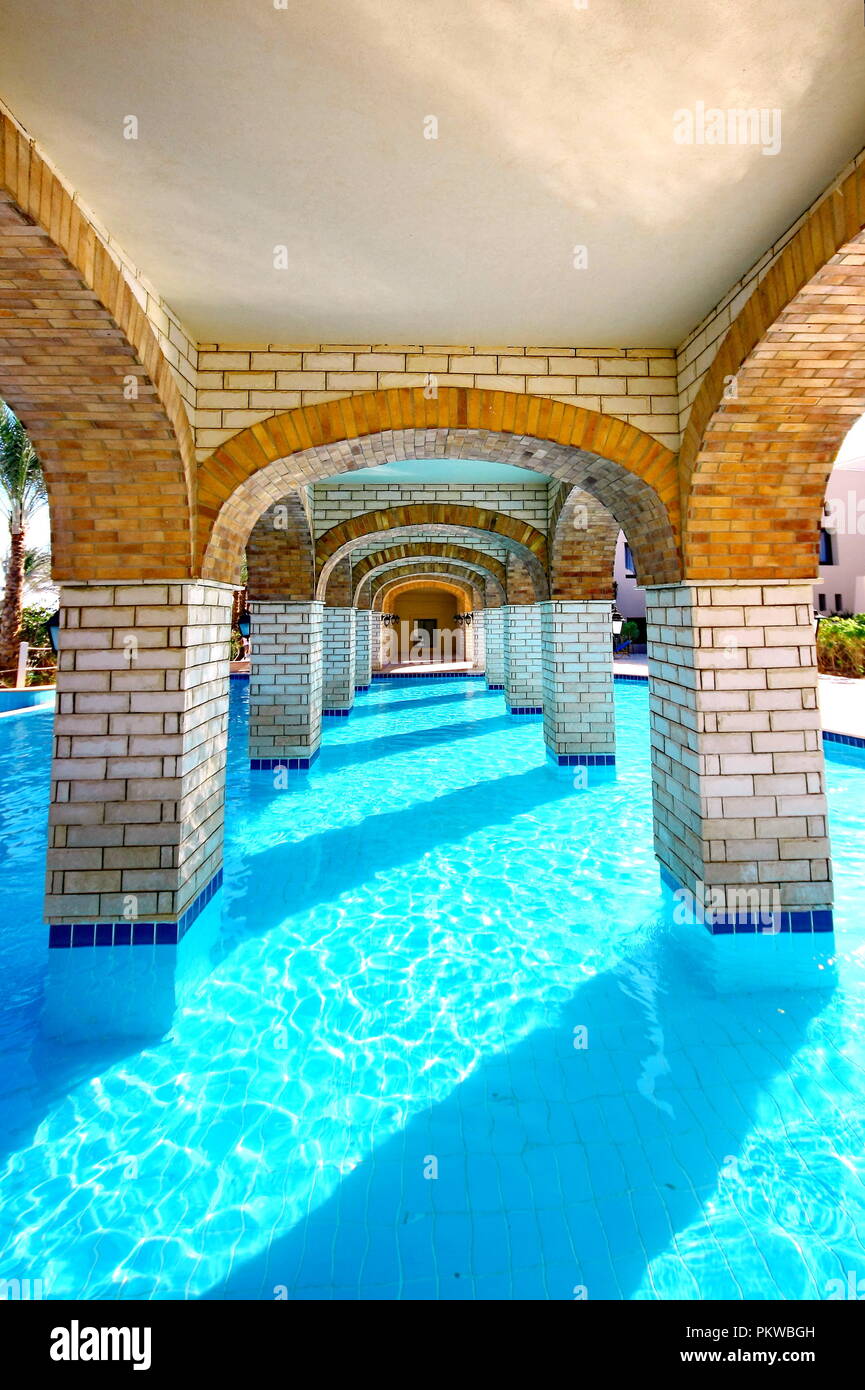 Panoramic swimming pool under bridge in resort Stock Photo - Alamy