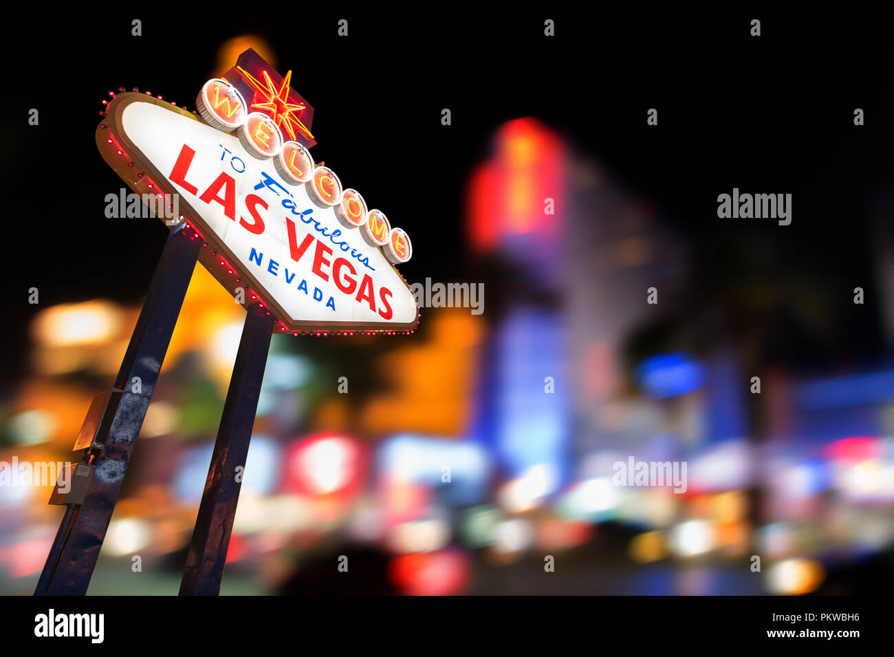 Famous Las Vegas sign at night with Las Vegas Cityscape blur background ...