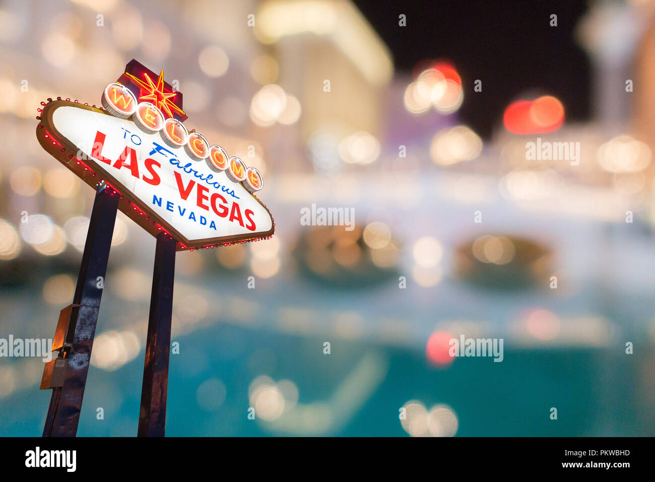 Famous Las Vegas sign at night with Las Vegas Cityscape blur background ...