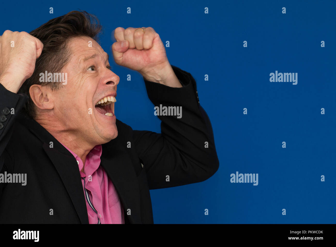 Exuberant excitement celebrating victory hi-res stock photography and ...