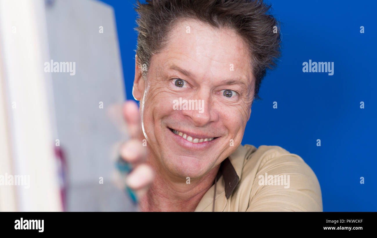 Very happy man with several books in hand. Glasses teacher, happy with ...