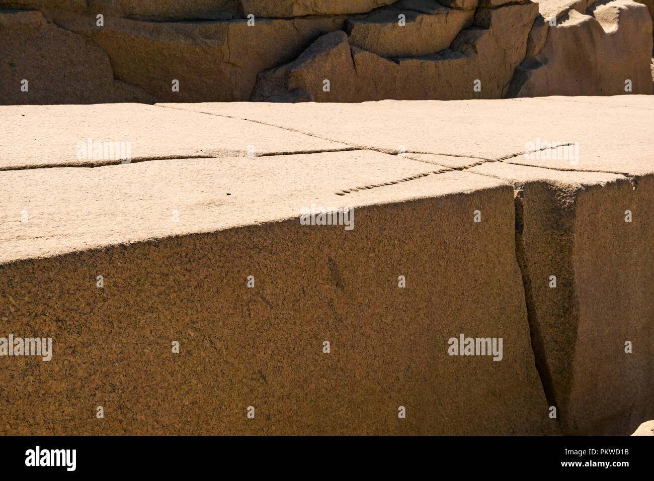 Close up of ancient Egyptian unfinished obelisk granite rock with crack ...