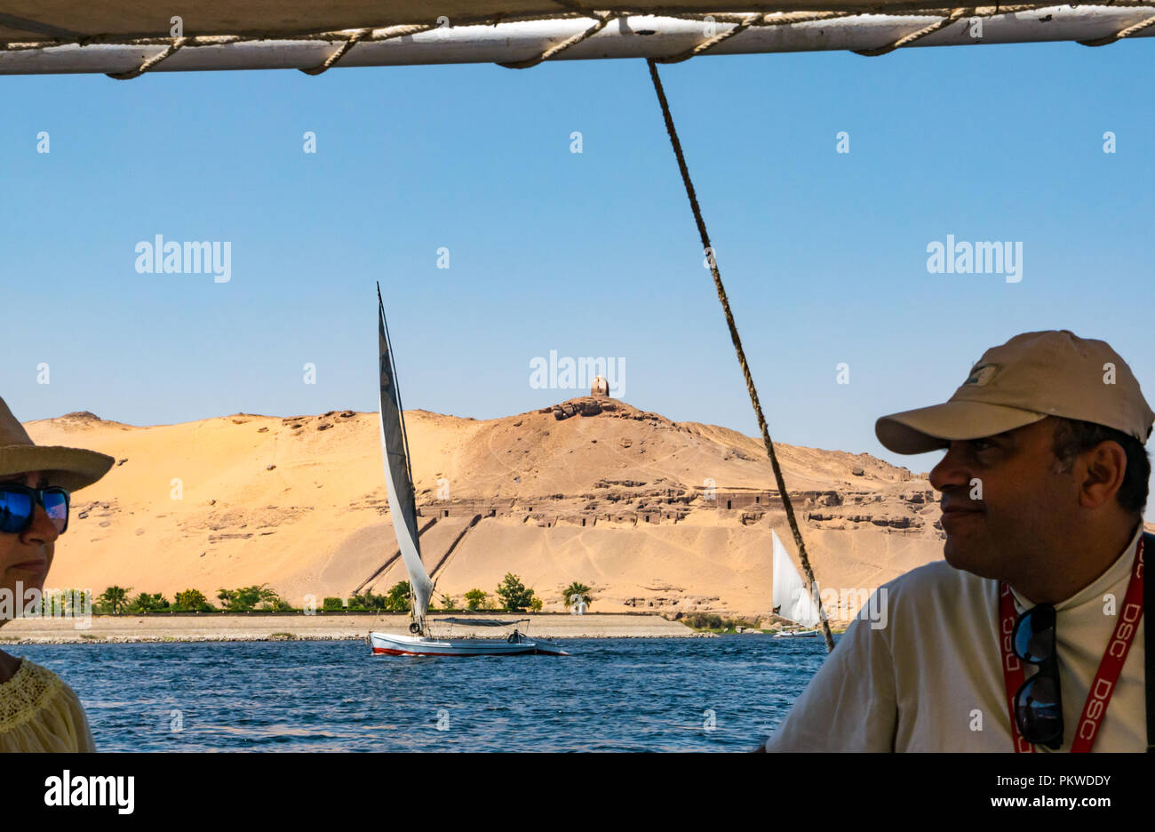 Egyptian man and woman in traditional felucca sailing boat with view of ...