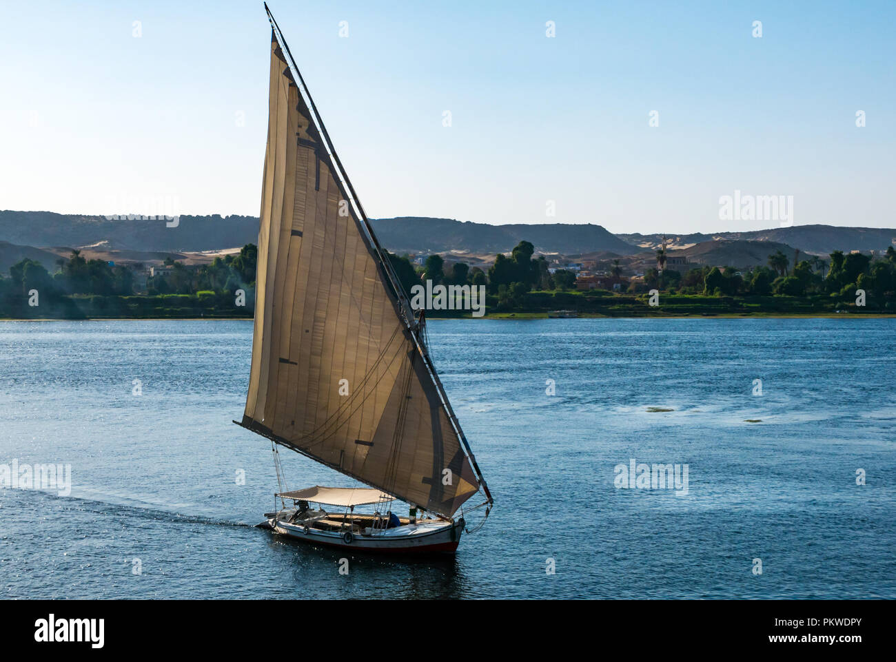 Traditional felucca sailing boat at dusk, River Nile, Aswan, Egypt ...