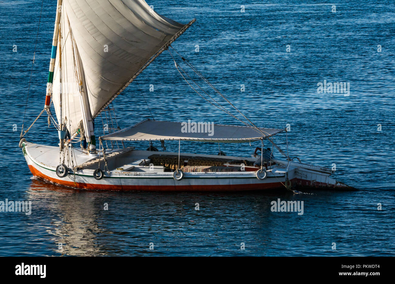 Traditional felucca sailing boat at dusk, River Nile, Aswan, Egypt ...