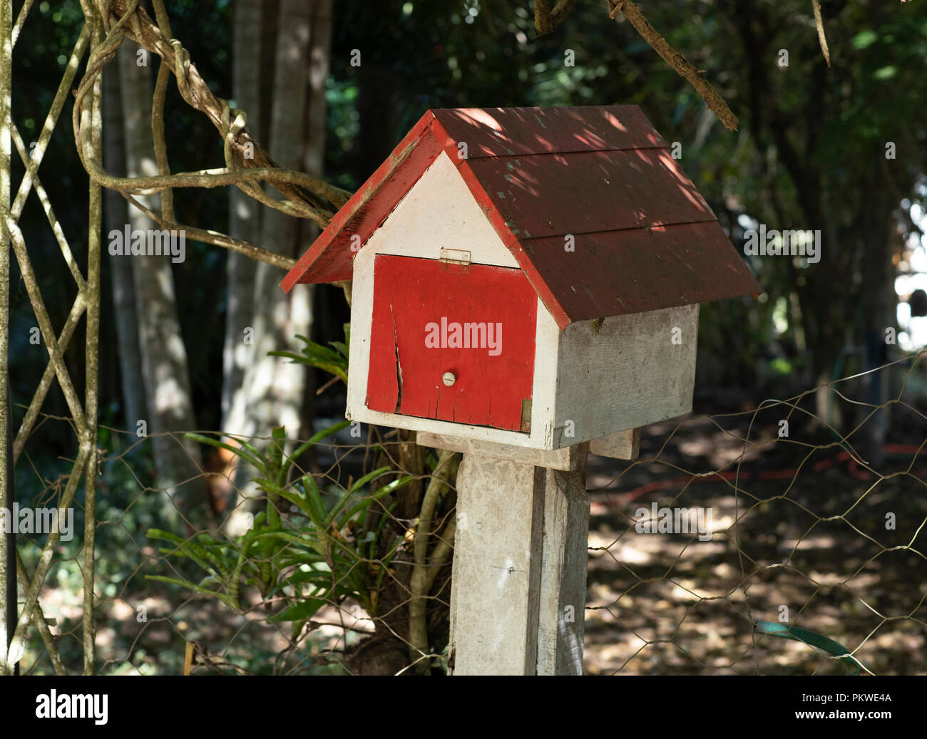 Mail house on house entrance in the garden. Painted wooden mail house ...