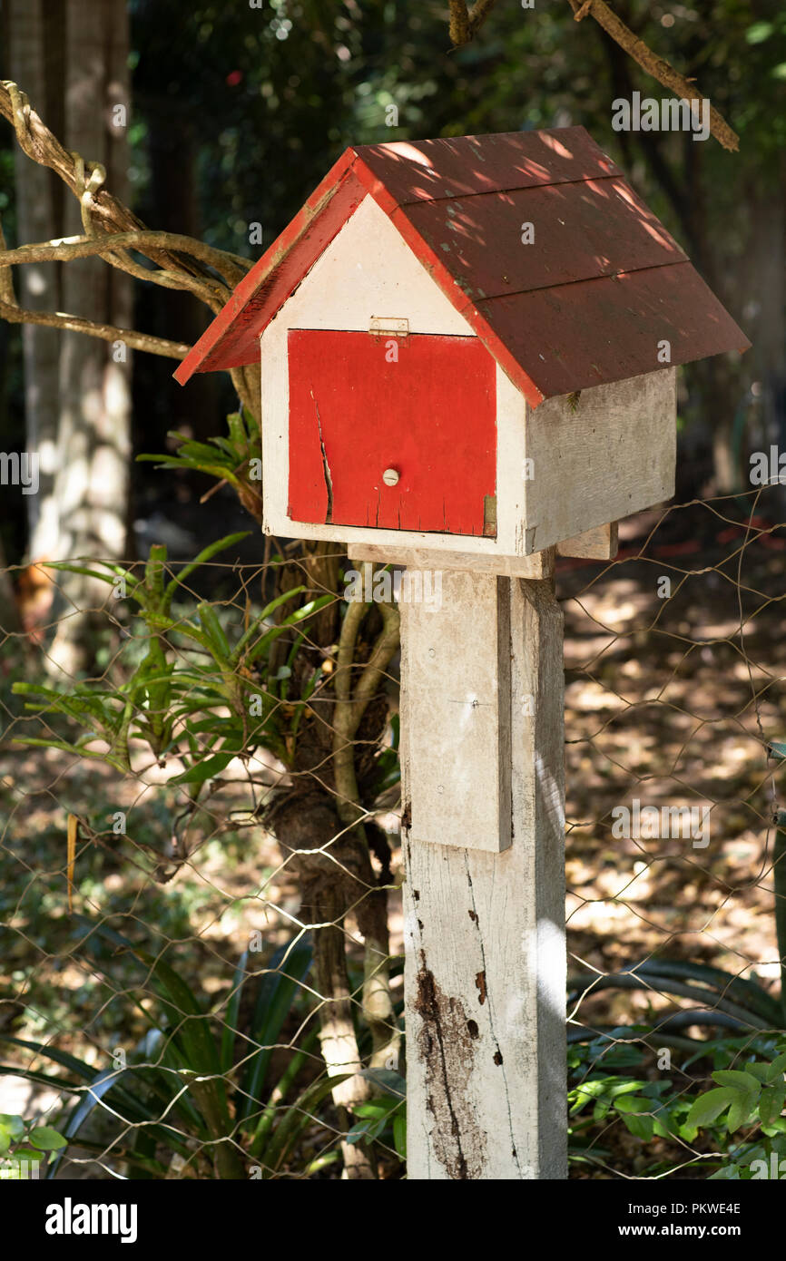Mail house on house entrance in the garden. Painted wooden mail house ...