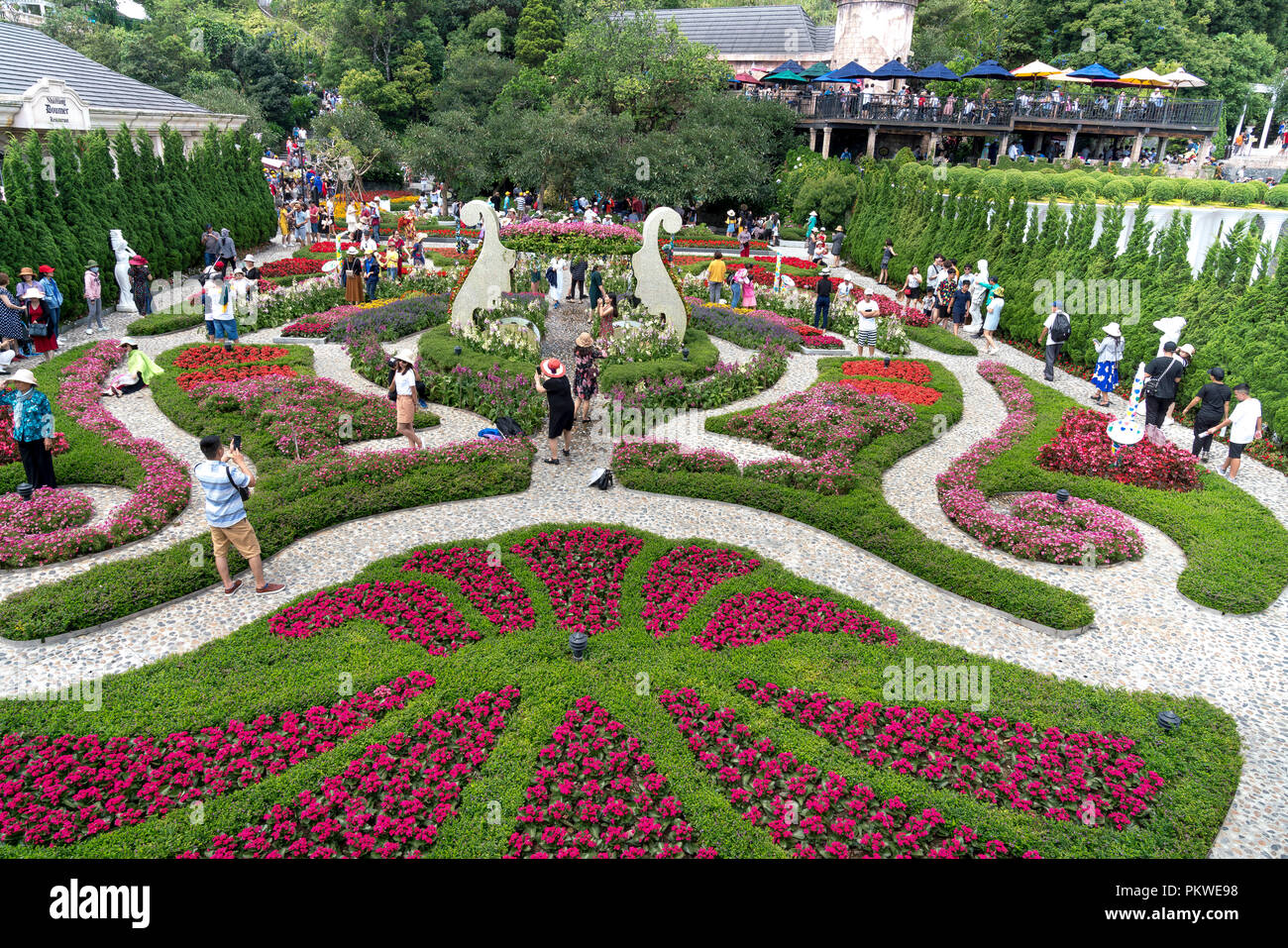 Tourists visit the beautiful flower garden of Ba Na Hill. Ba Na Hill ...