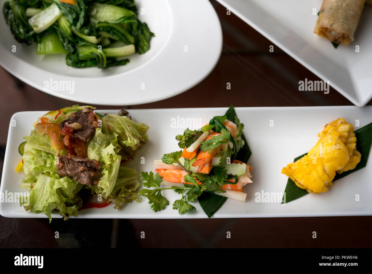 Vietnamese rice with vegetables and fried spring rolls Stock Photo - Alamy