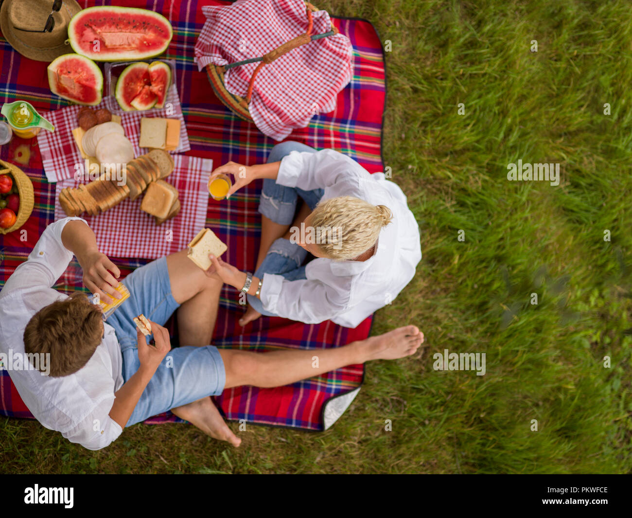 Couple in love enjoying picnic time drink and food in beautiful nature ...