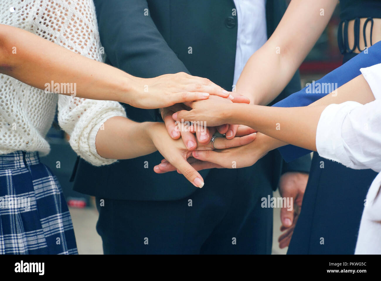 Business teamwork holding hands together Stock Photo - Alamy