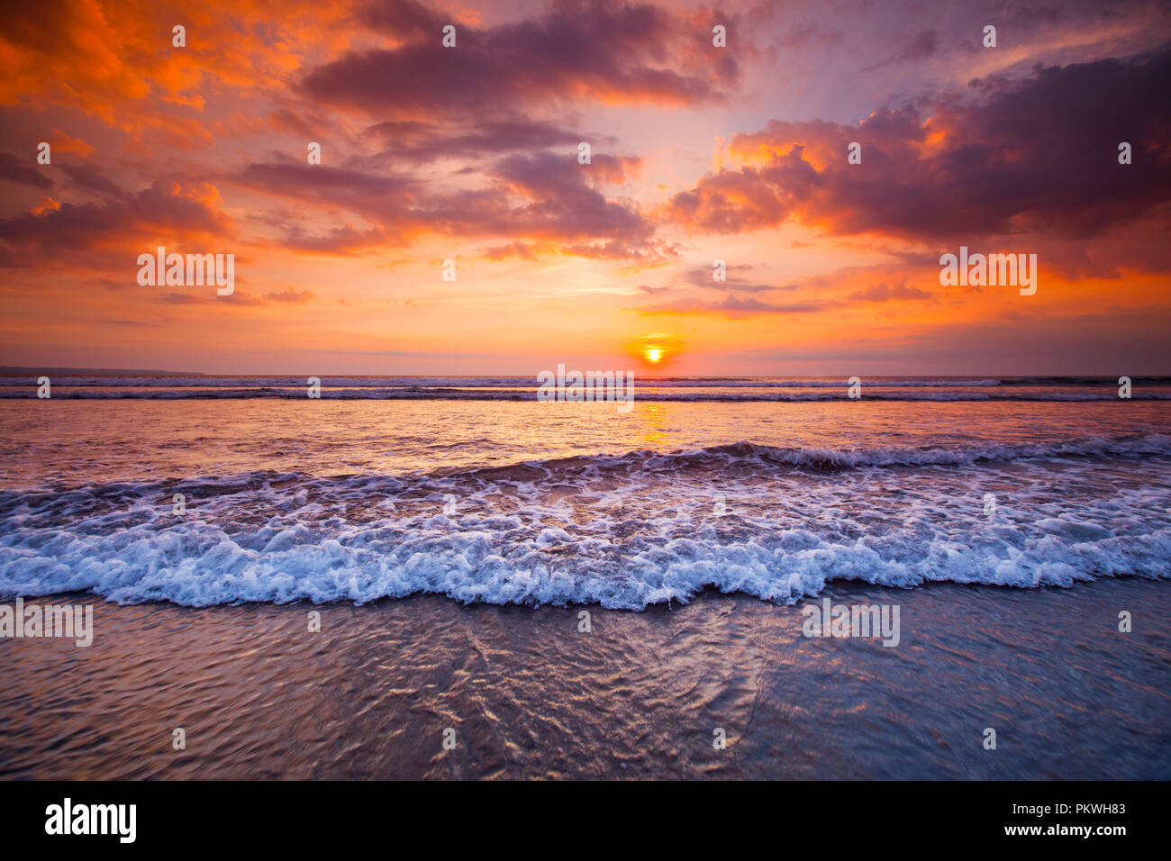 Radiant colorful sea beach sunset on Bali, Indonesia Stock Photo - Alamy
