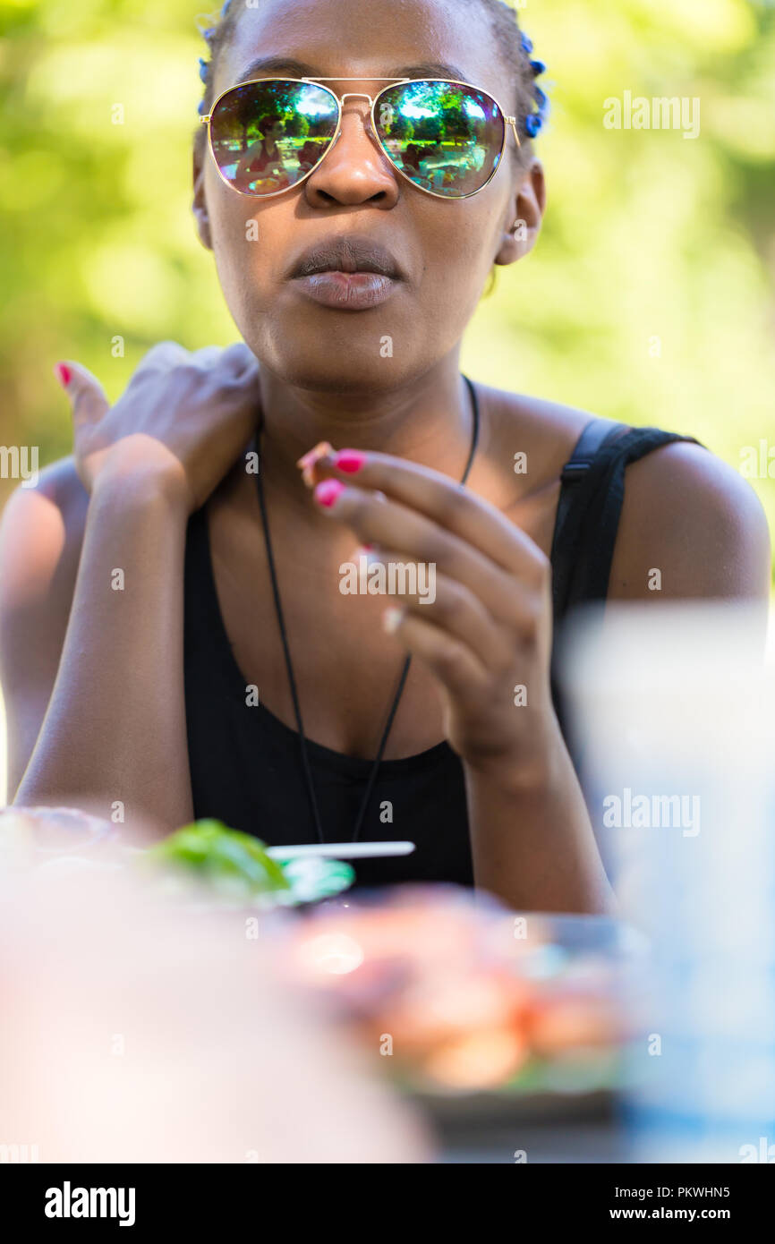 Stylish teenage girl having dinner Stock Photo - Alamy