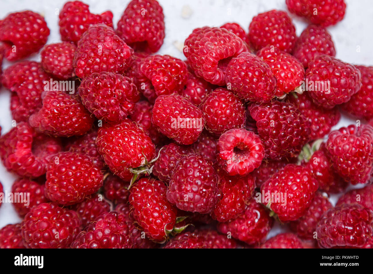 Fresh and sweet raspberries background Stock Photo - Alamy