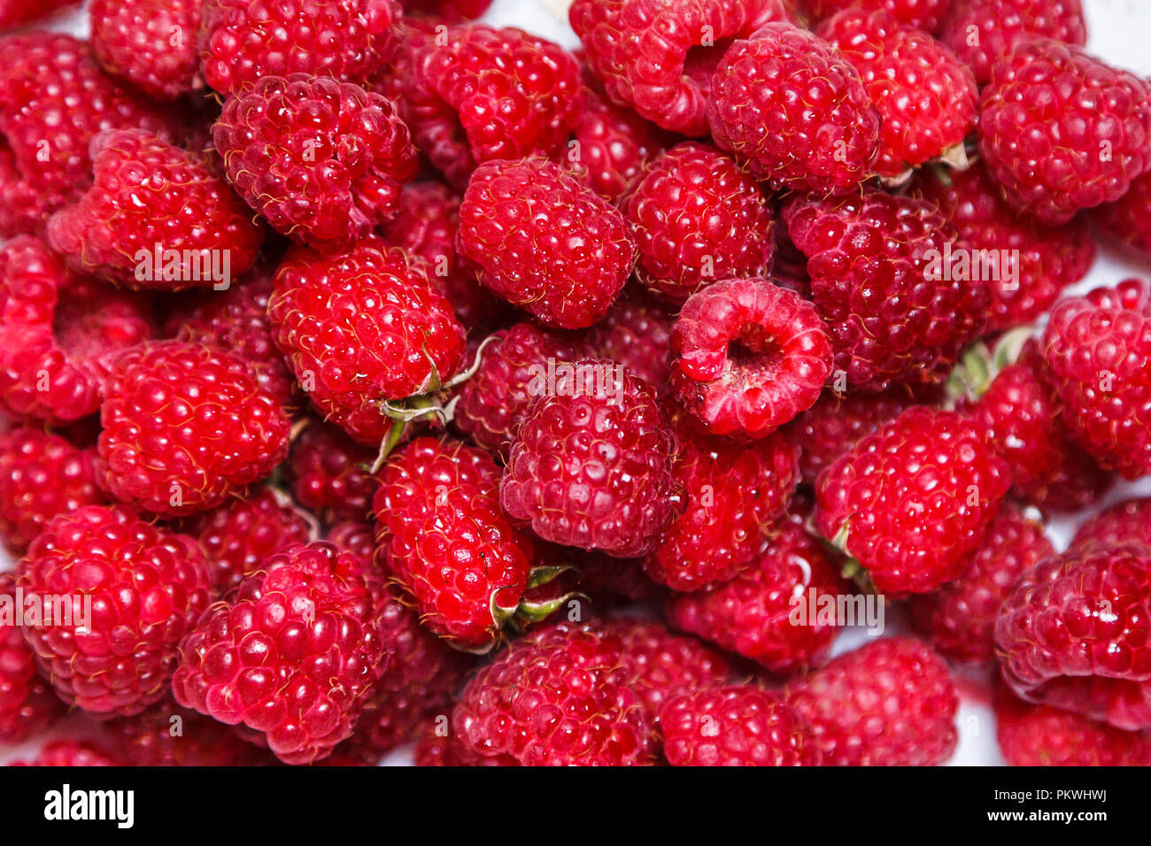 Fresh and sweet raspberries background Stock Photo - Alamy