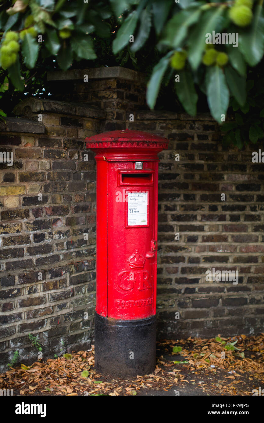 A bright red cast iron traditional British post box owned by Royal Mail ...