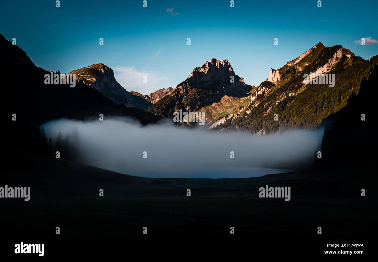 fog covered mountain lake during sunrise morning switzerland alpstein ...