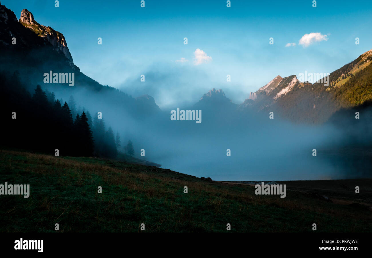 fog covered mountain lake during sunrise morning switzerland alpstein ...
