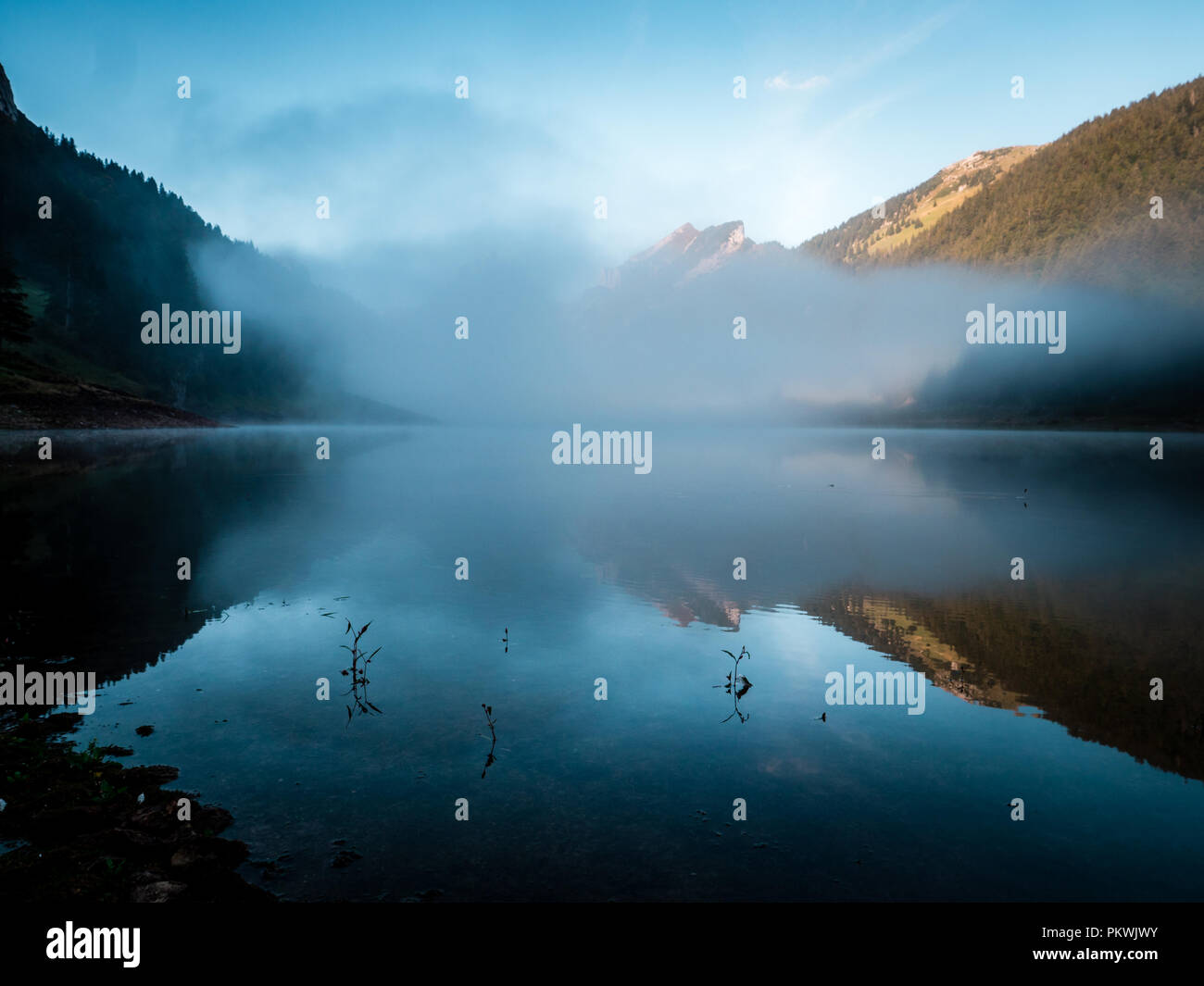 fog covered mountain lake during sunrise morning switzerland alpstein ...