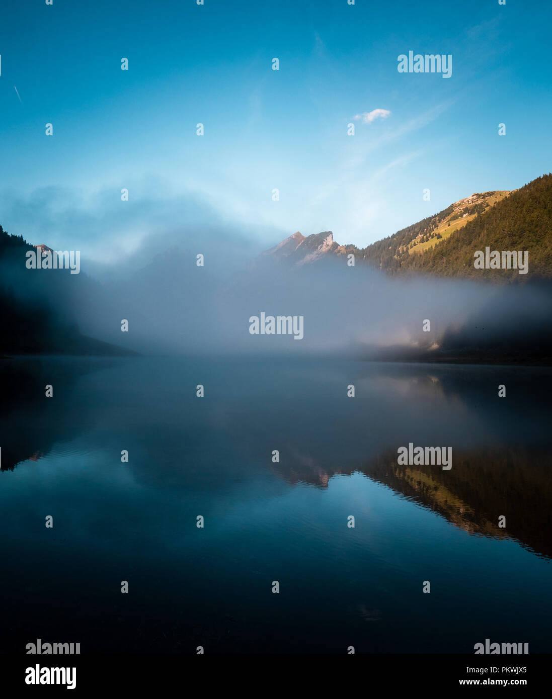fog covered mountain lake during sunrise morning switzerland alpstein ...