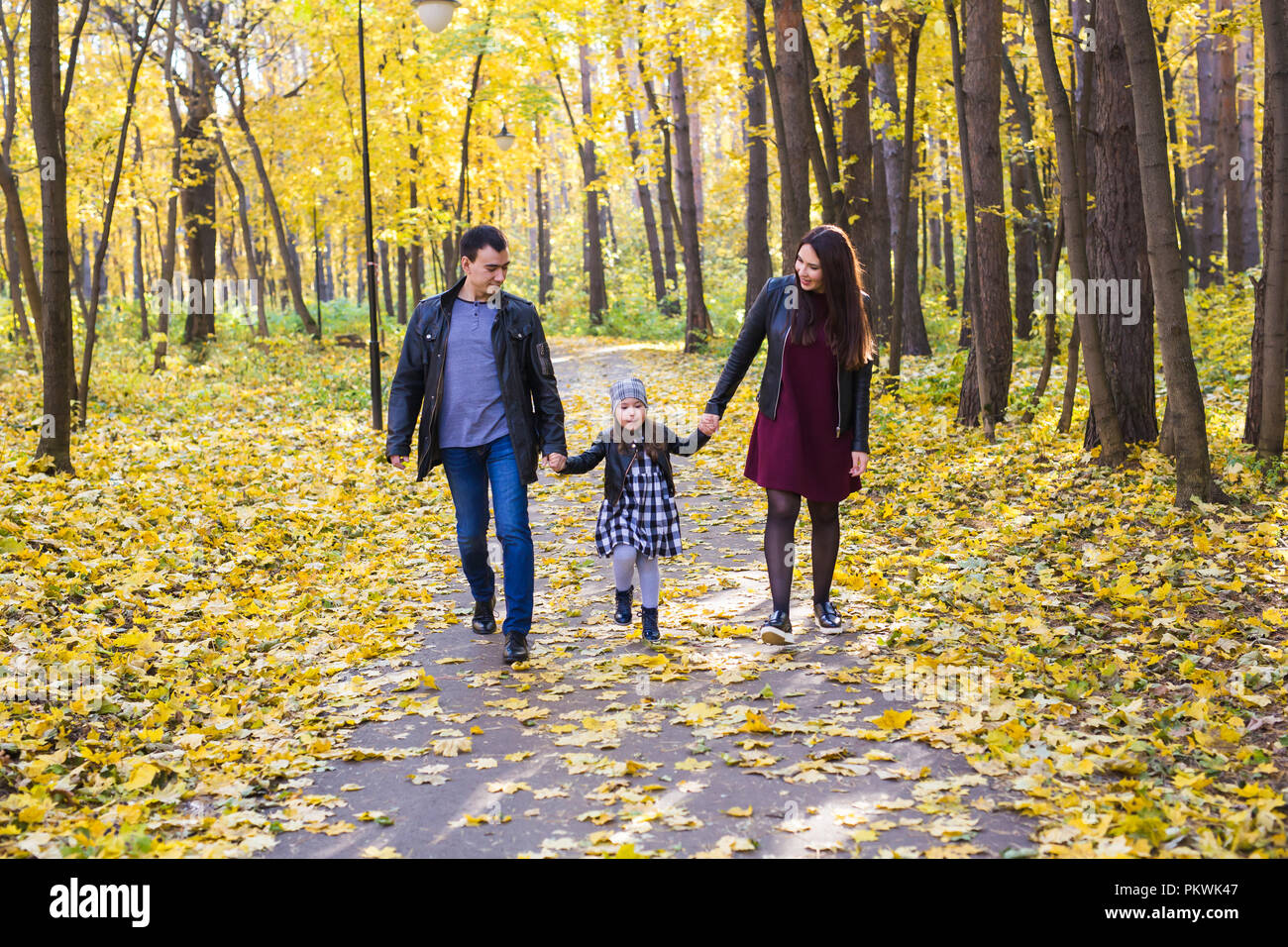 Parks, nature and family concept - Happy family walking in autumn park ...