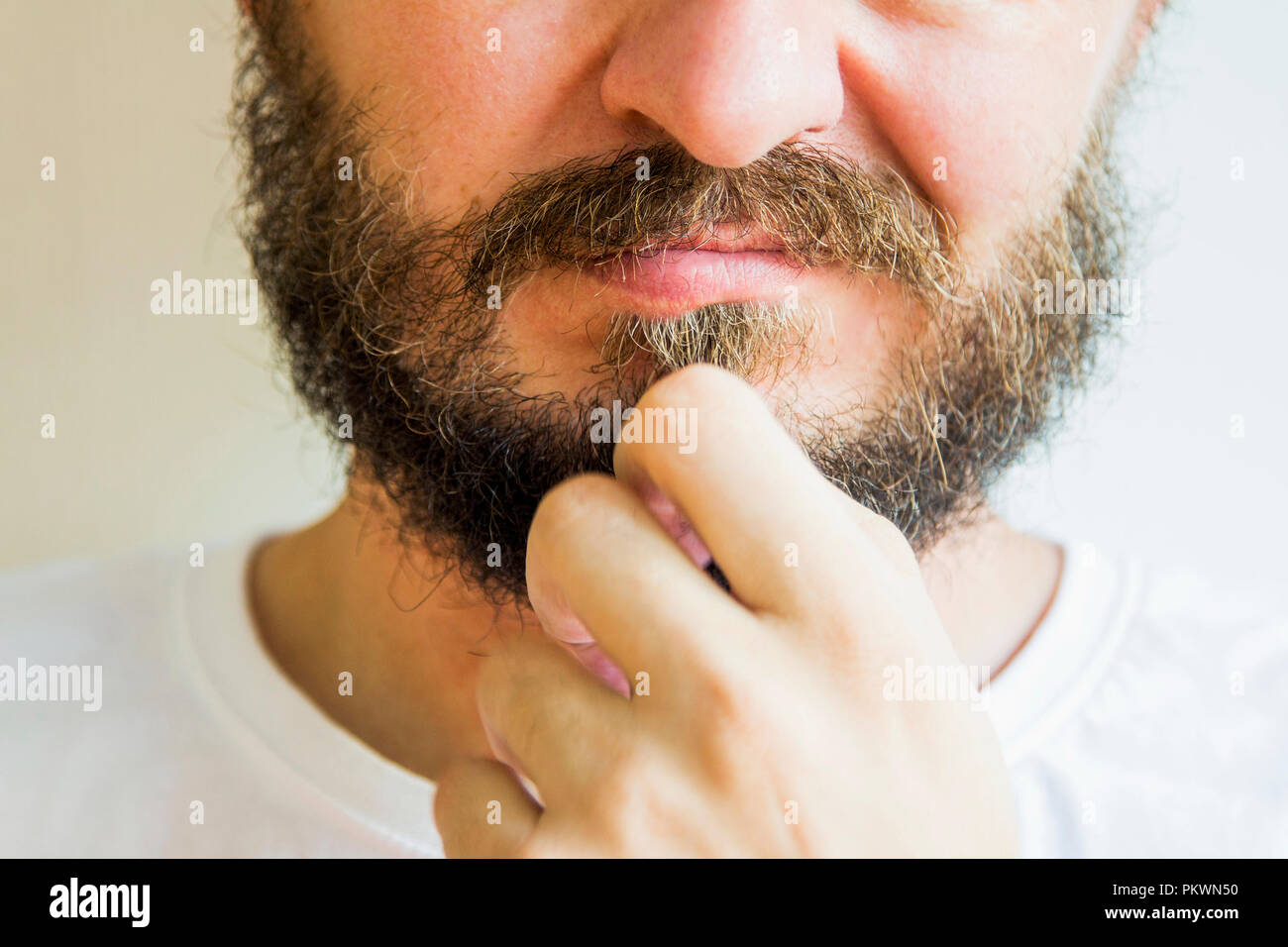 Man with beard and mustaches, skeptic expression Stock Photo - Alamy