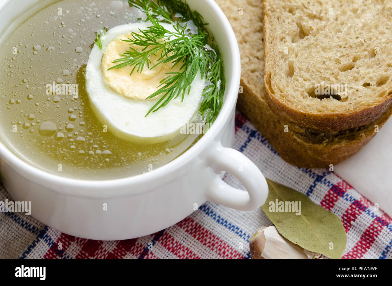 Chicken bouillon with egg and dill in the white bowl Stock Photo - Alamy