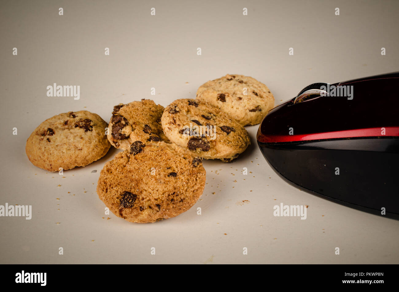 Mouse eating cookies, a funny technology concept Stock Photo - Alamy