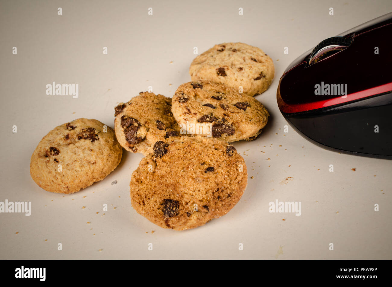 Mouse eating cookies, a funny technology concept Stock Photo - Alamy