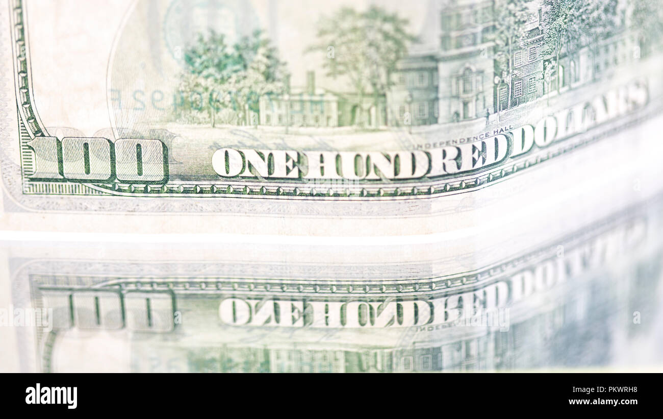 blurred dollar money background and mirror like concept of success ...