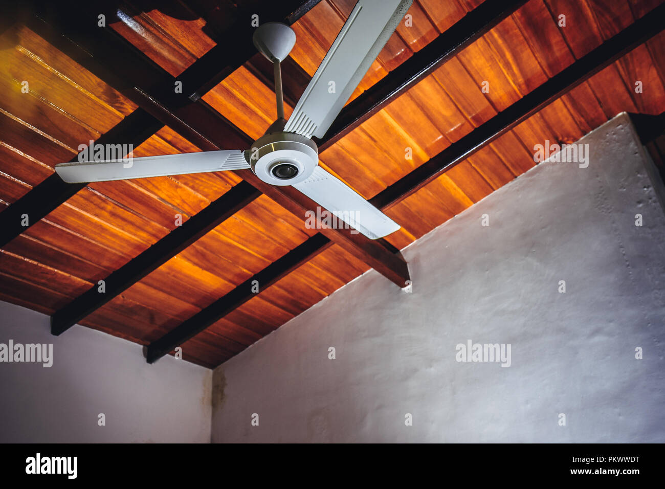 Ceiling fan on the background of a brown wooden ceiling Stock Photo - Alamy