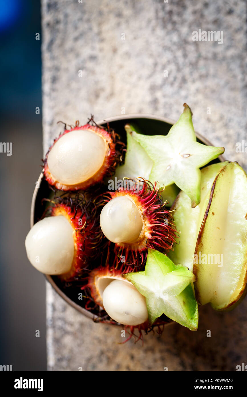 Exotic hairy fruit rambutan in rustic style Stock Photo - Alamy