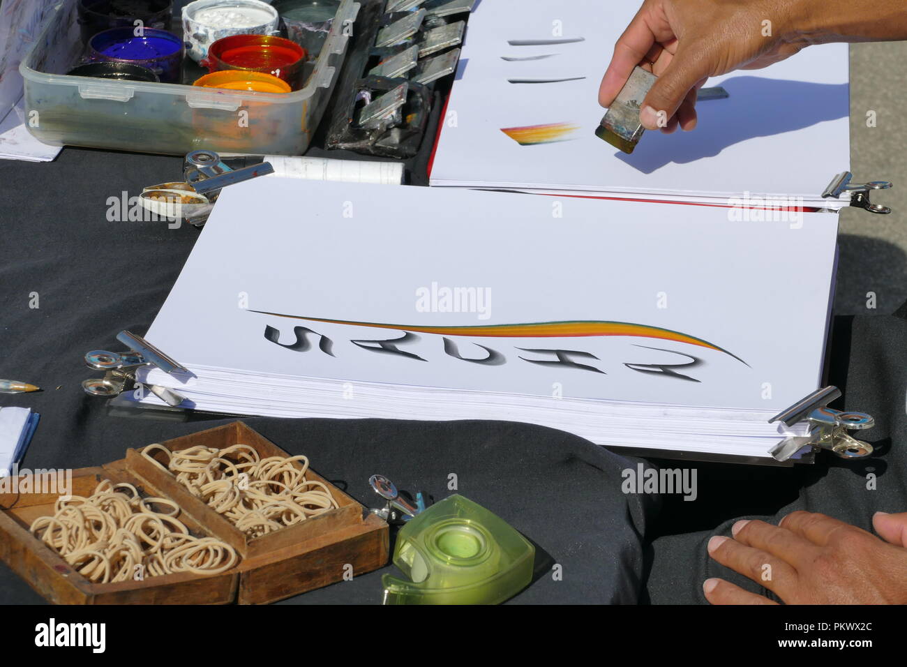 Street painter drawing christian name Stock Photo - Alamy