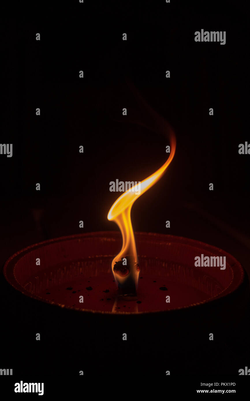 Candle flame close up on dark background, interesting flame figure ...