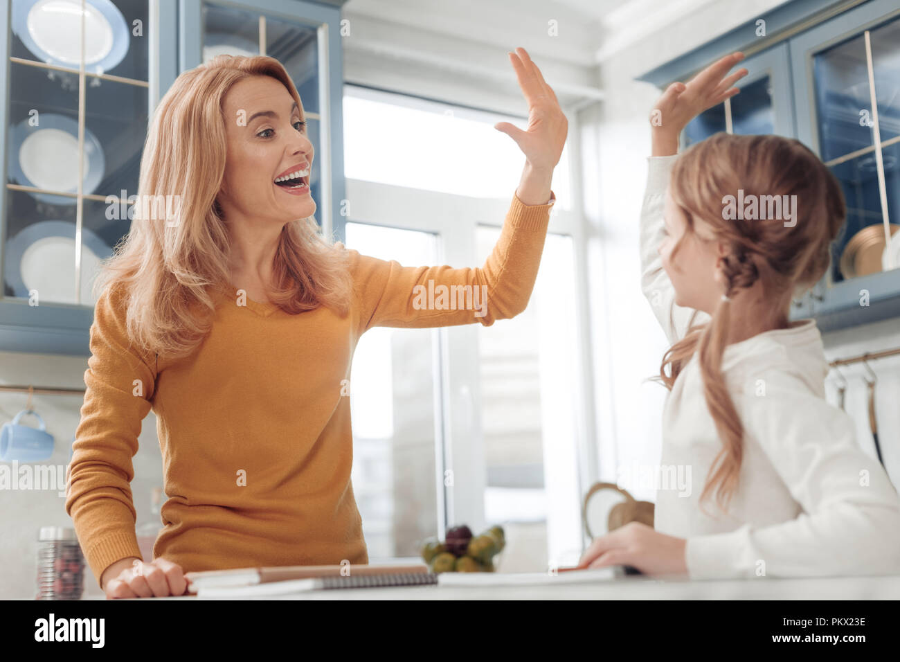 Kind adult mother touching hands with daughter Stock Photo - Alamy