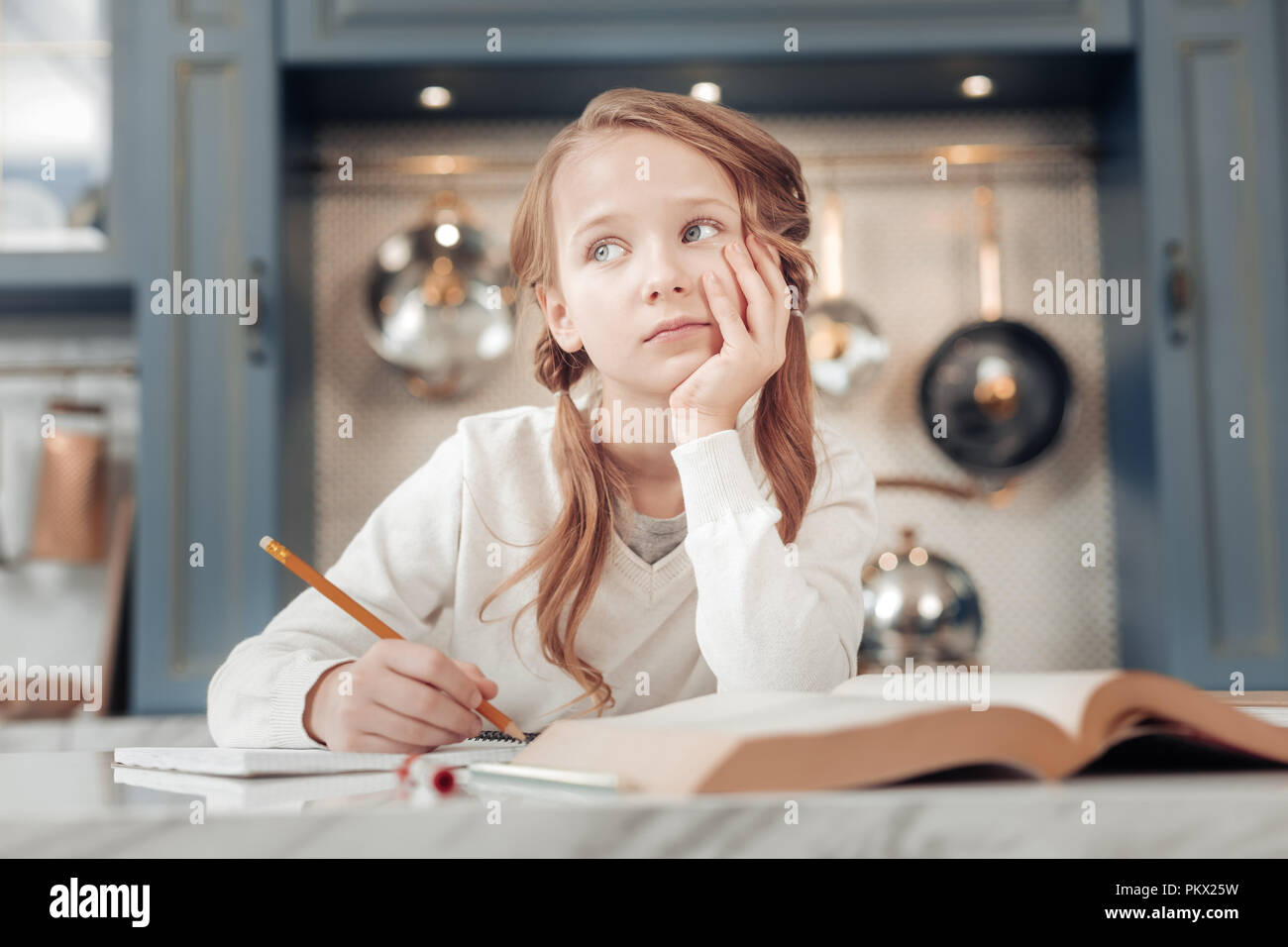 Dreamy little girl being deep in thoughts Stock Photo - Alamy