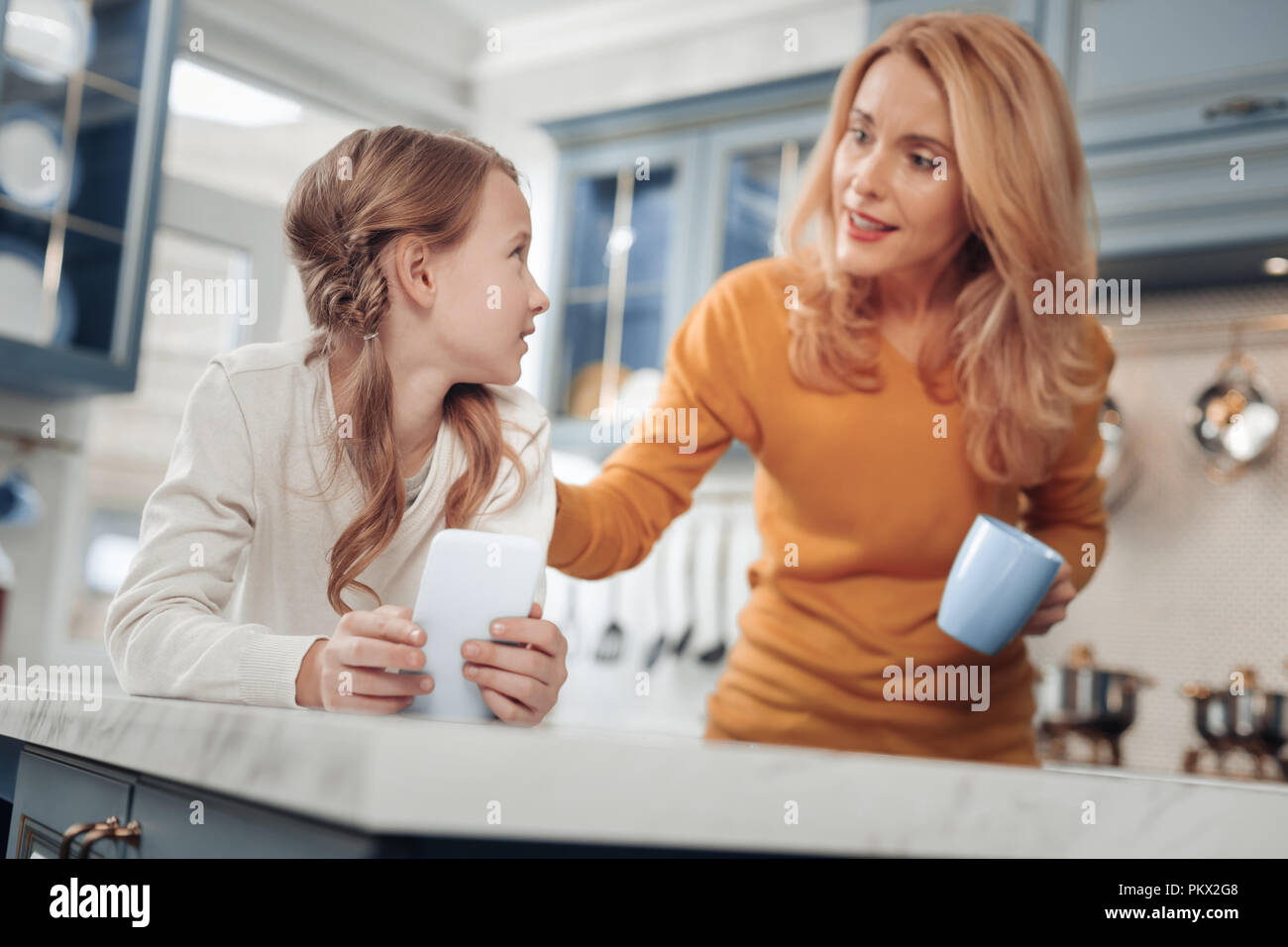 Kind loving woman talking to her daughter Stock Photo - Alamy