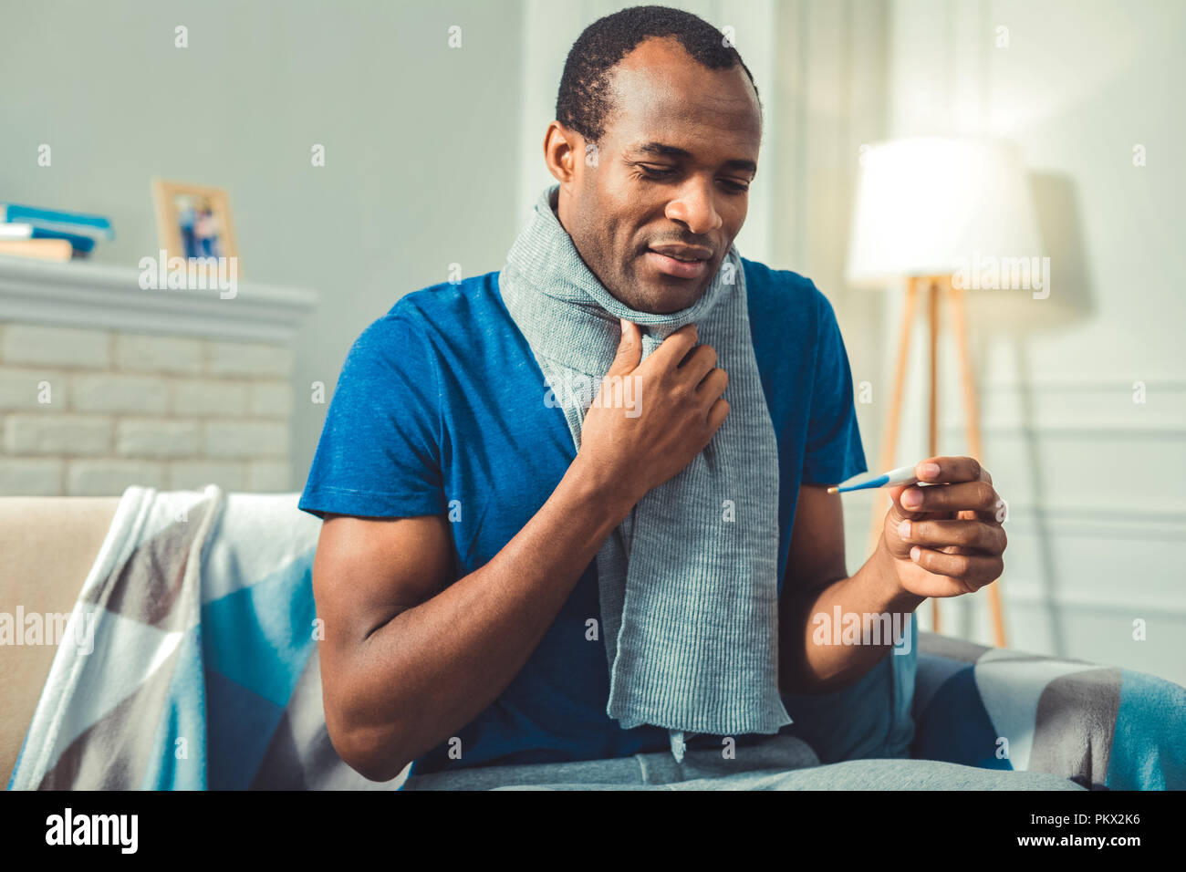Serious adult afro american man having fever Stock Photo - Alamy