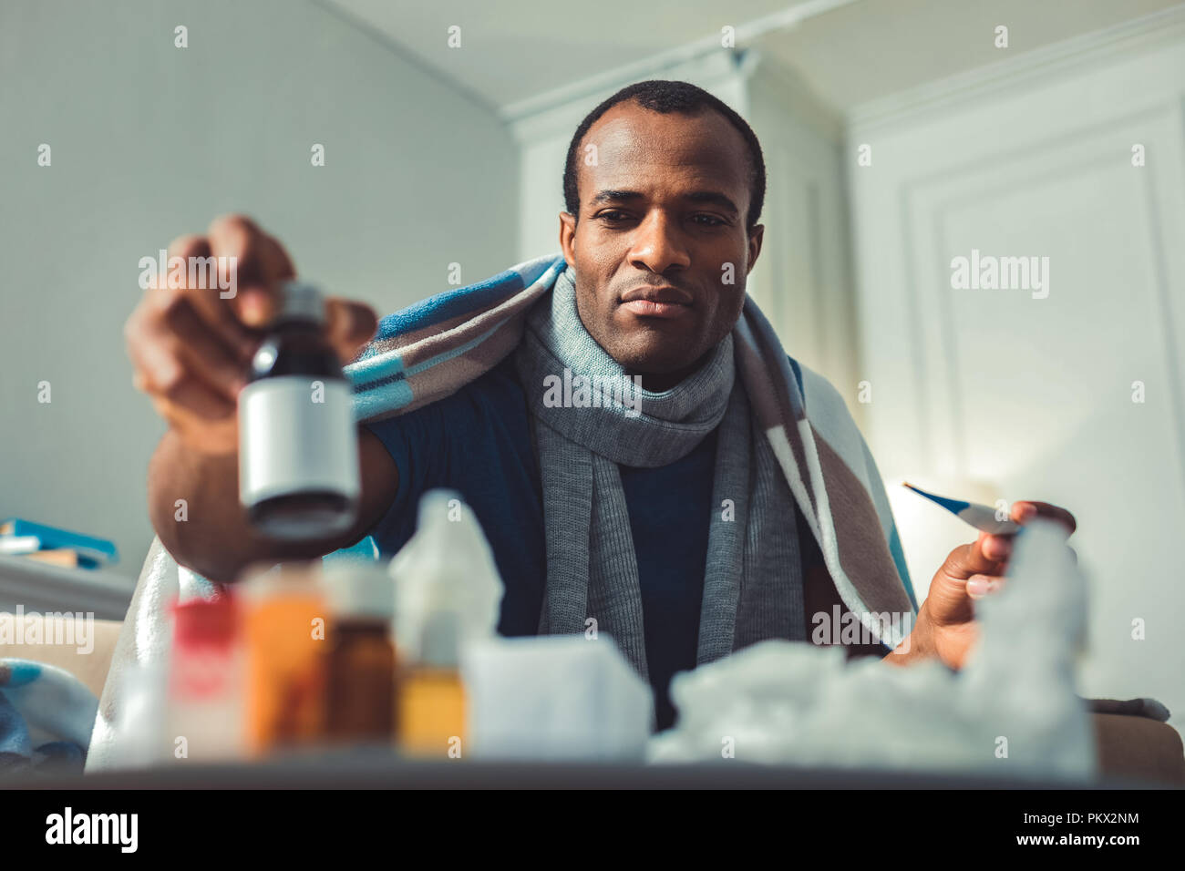 Calm afro american man stretching for medication Stock Photo - Alamy