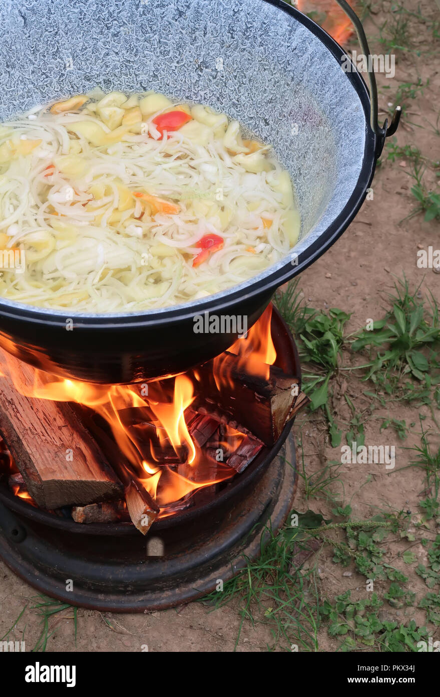 A stew cooked in cauldron over fire Stock Photo - Alamy