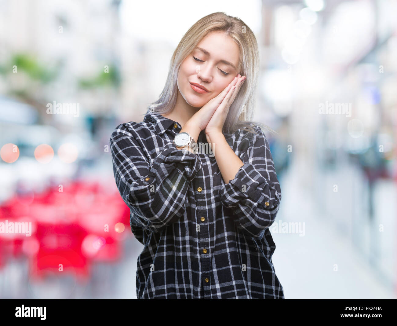 Young blonde woman over isolated background sleeping tired dreaming and ...
