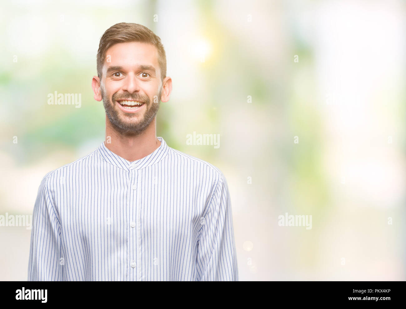 Young handsome man over isolated background with a happy and cool smile ...