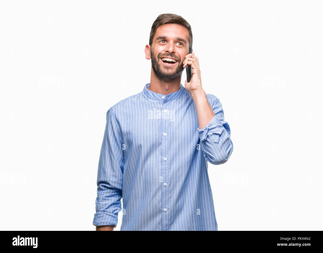Young handsome man speaking on the phone over isolated background with ...