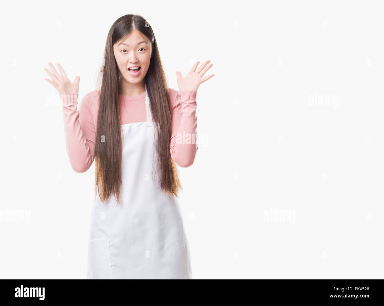 Young Chinese shop owner woman over isolated background wearing white ...
