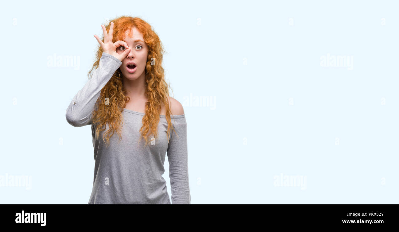 Young redhead woman doing ok gesture shocked with surprised face, eye ...