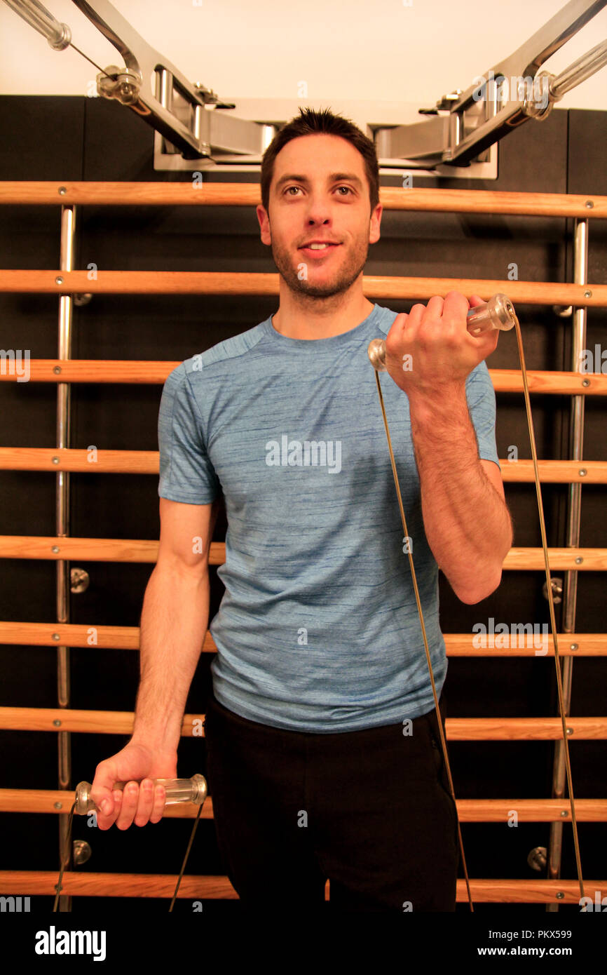 Man working fitness sport exercise for biceps on kinesis technology ...