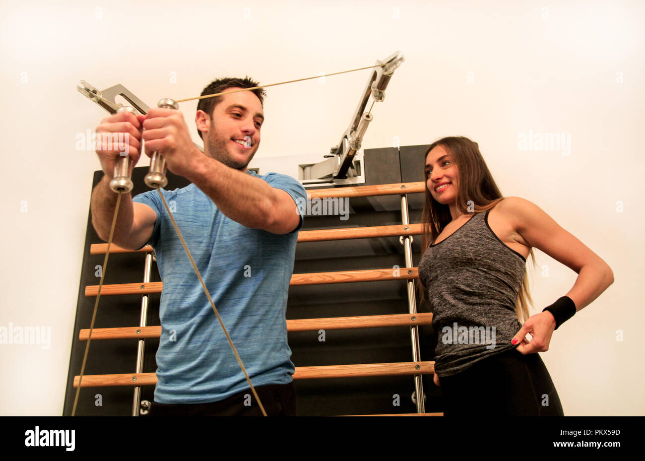Exercise for the chest. Young woman exercise in a gym with the help of ...