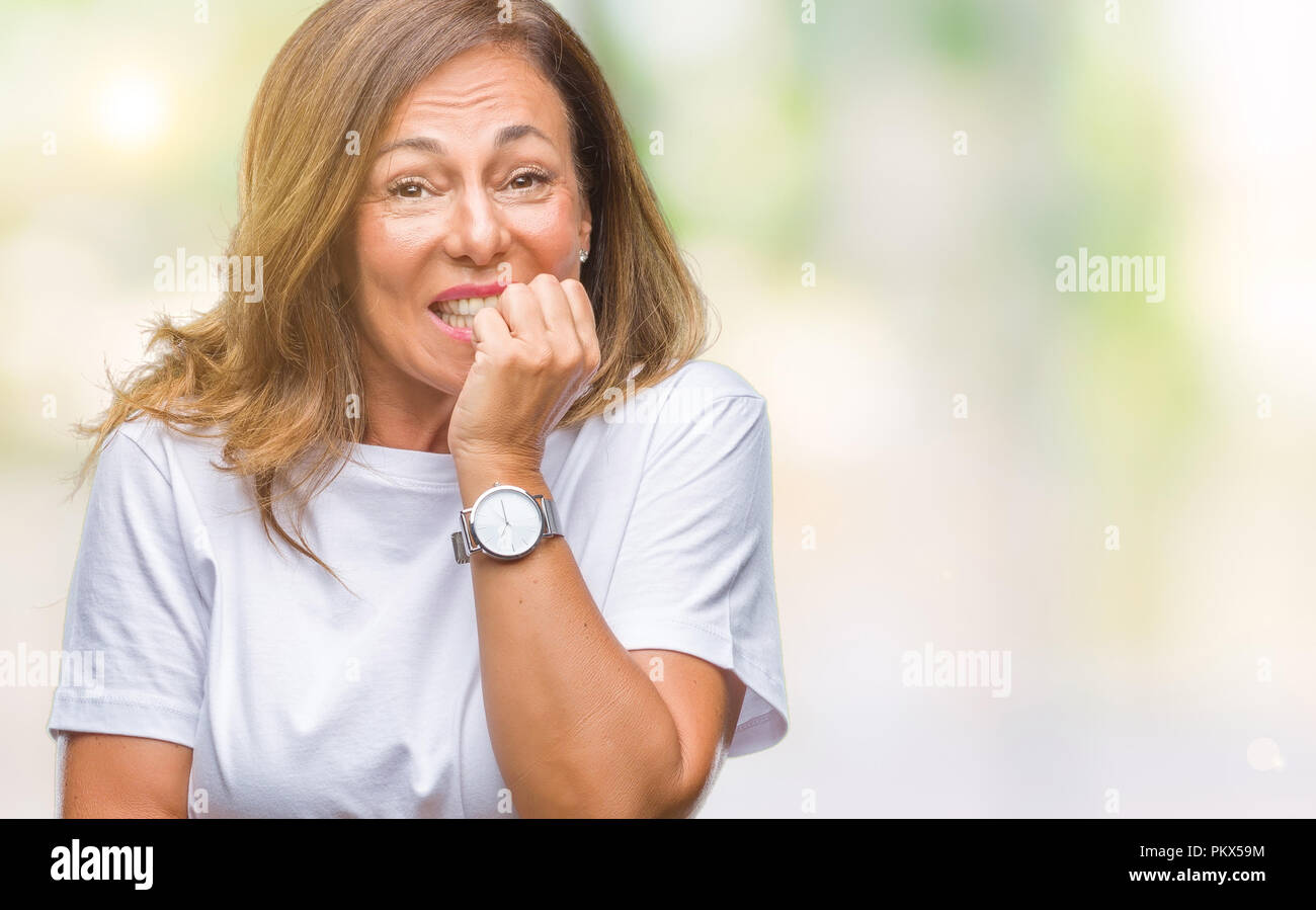 Middle age senior hispanic woman over isolated background looking ...