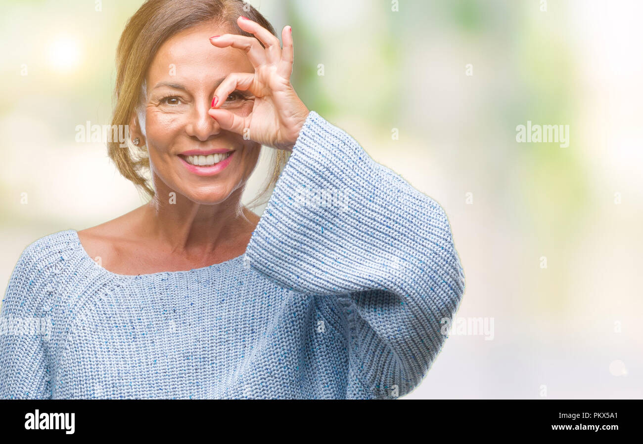 Middle age senior hispanic woman wearing winter sweater over isolated ...